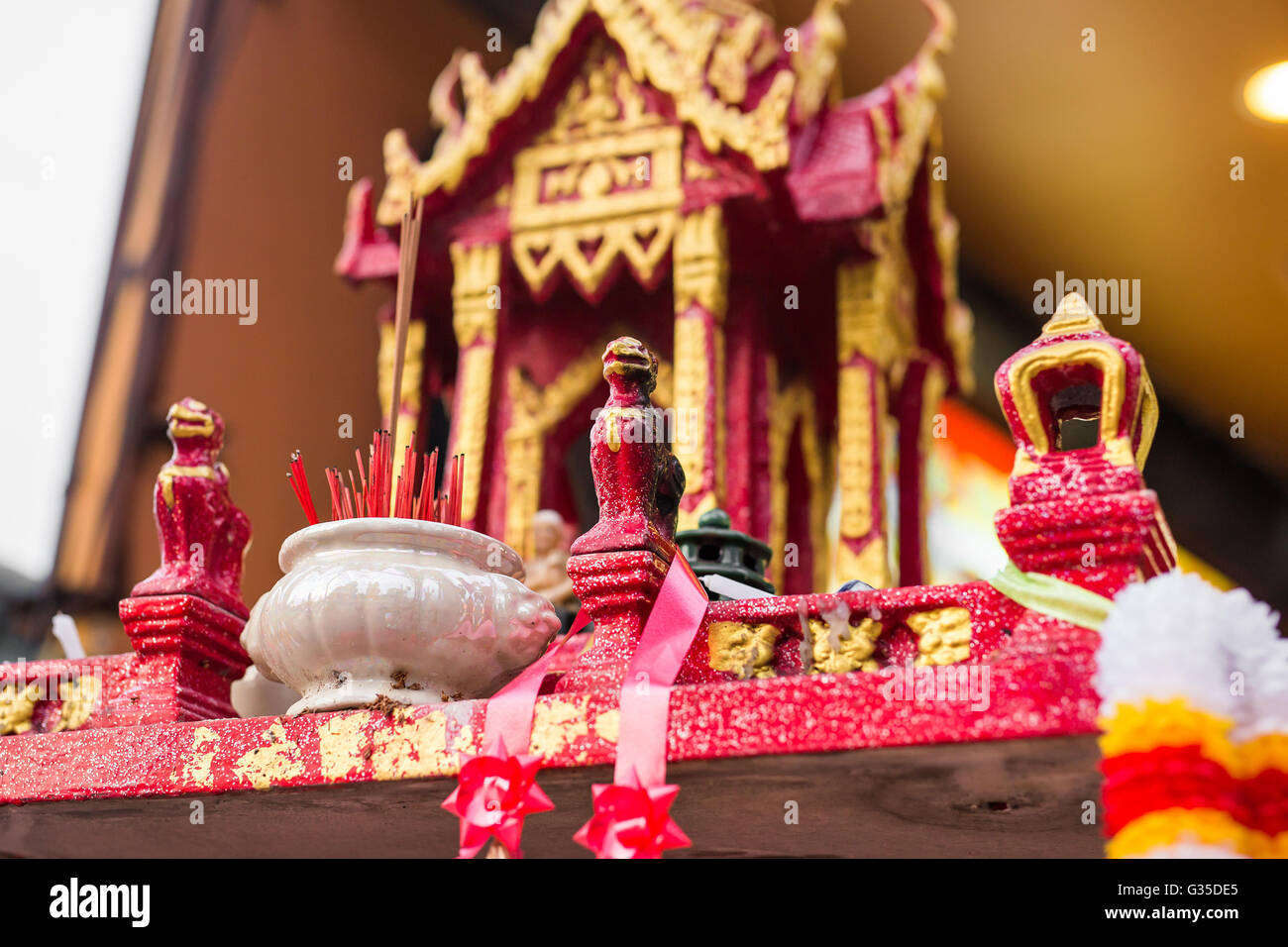 Outdoor spirit house in Thailand. garland and some wreathes, joss house ...