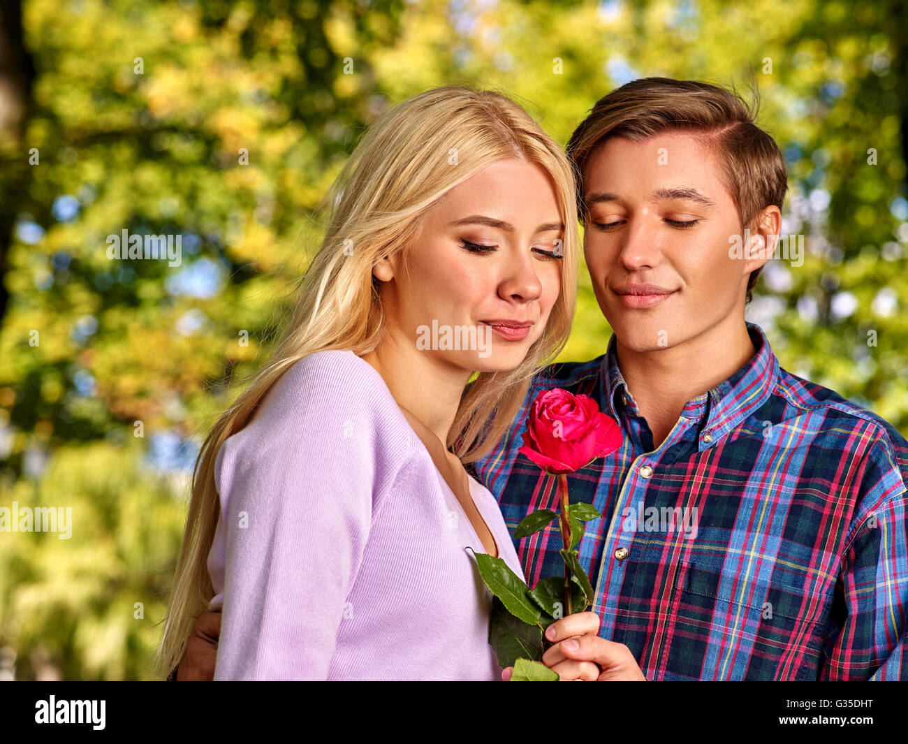 Couple keeps red rose flower Stock Photo - Alamy
