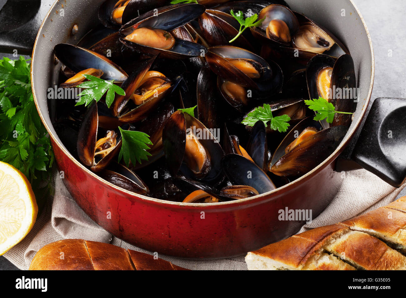 Mussels and homemade bread on stone table Stock Photo - Alamy