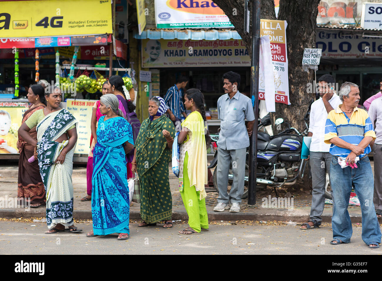 A group of Indian people waiting for a local bus in Mylapore, Chennai ...