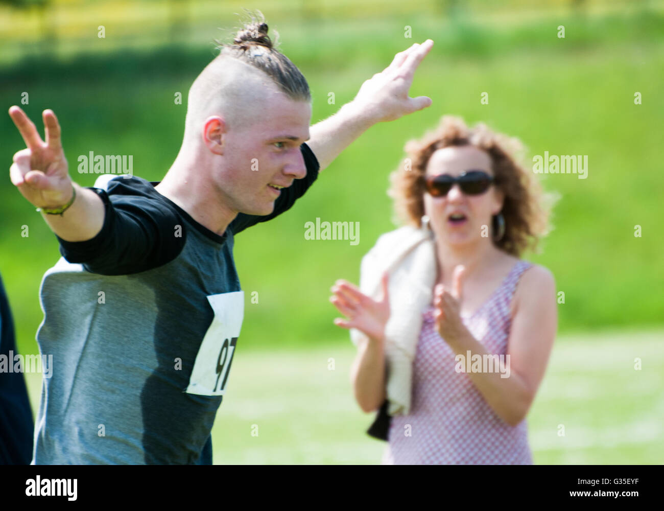 Young male adult finishes fun run making victory sign Stock Photo - Alamy
