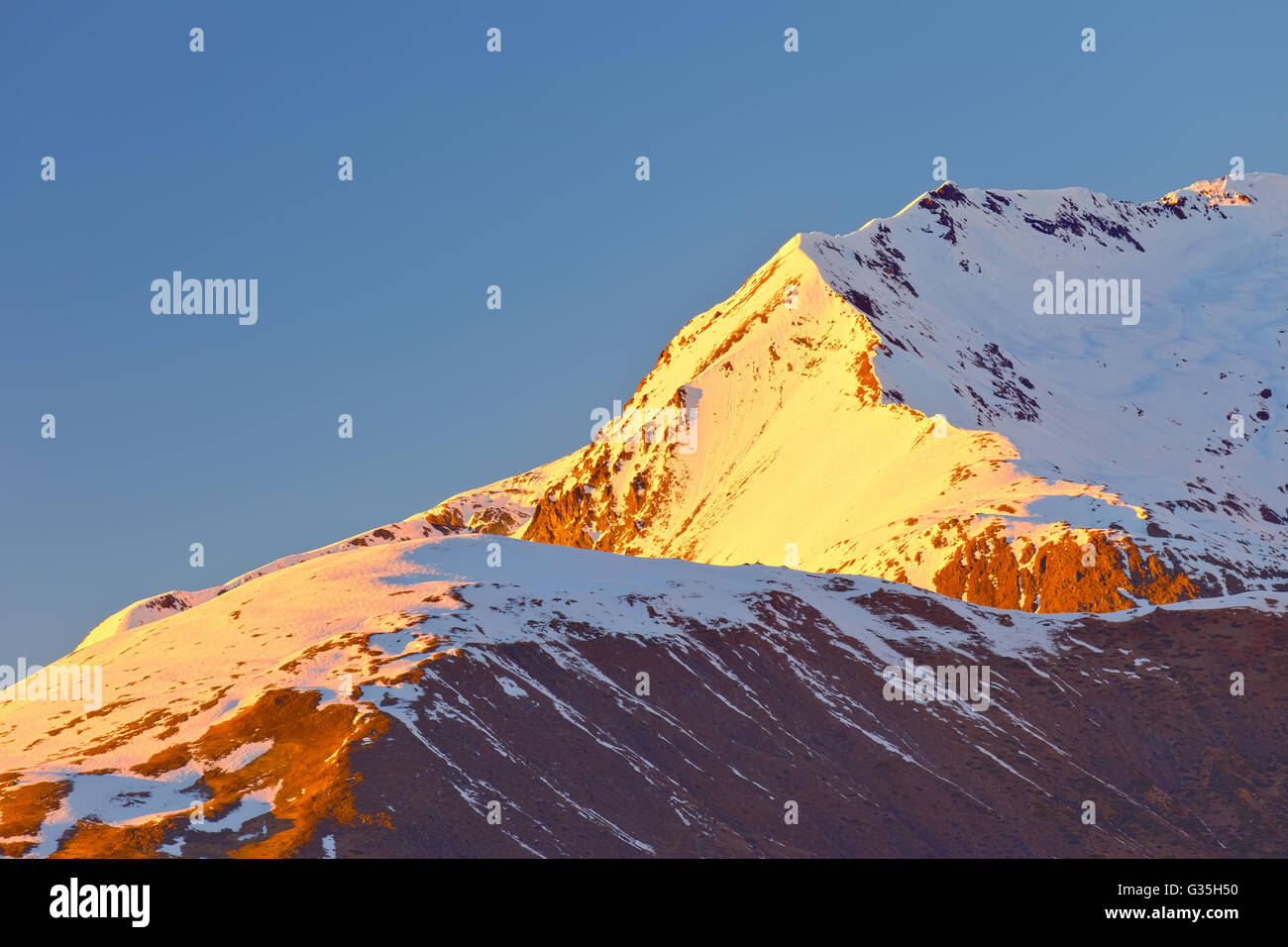 Alpine peak at sunset Stock Photo - Alamy