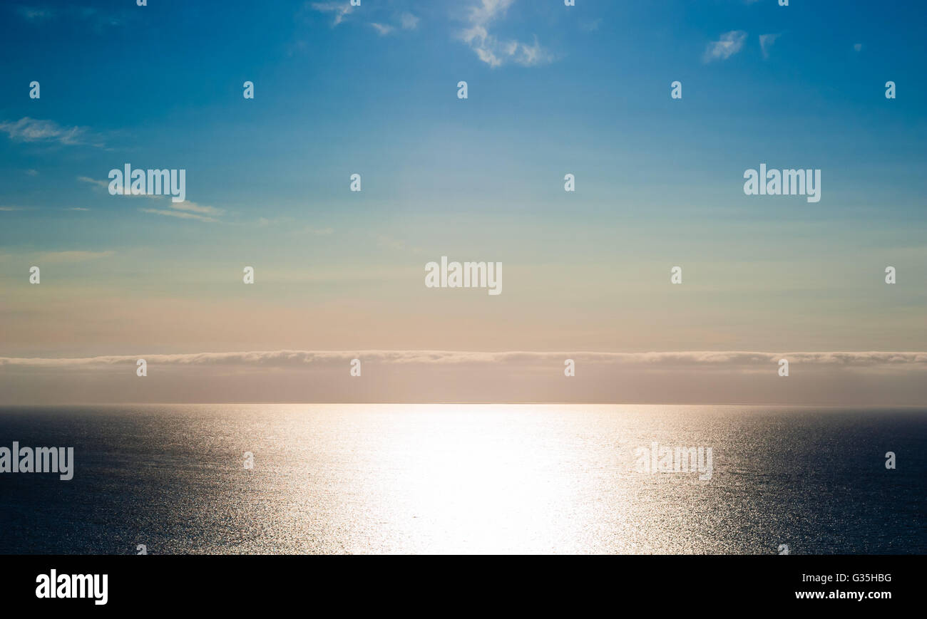 Expansive empty ocean seascape brightly illuminated by sunshine, with ...