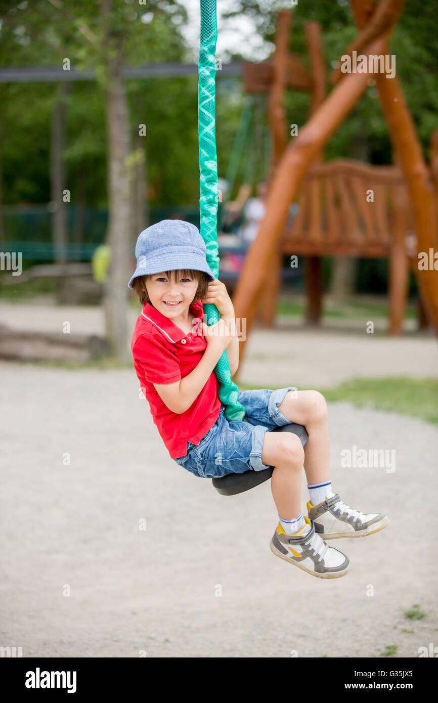 Cute child, boy, rides on Flying Fox play equipment in a children's ...
