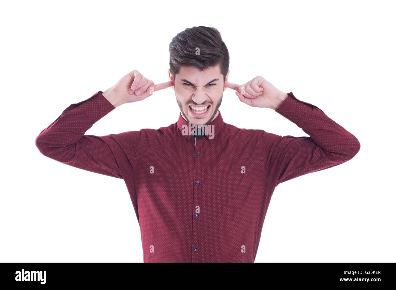 Angry, stressed man covering his ears. Isolated on white background ...