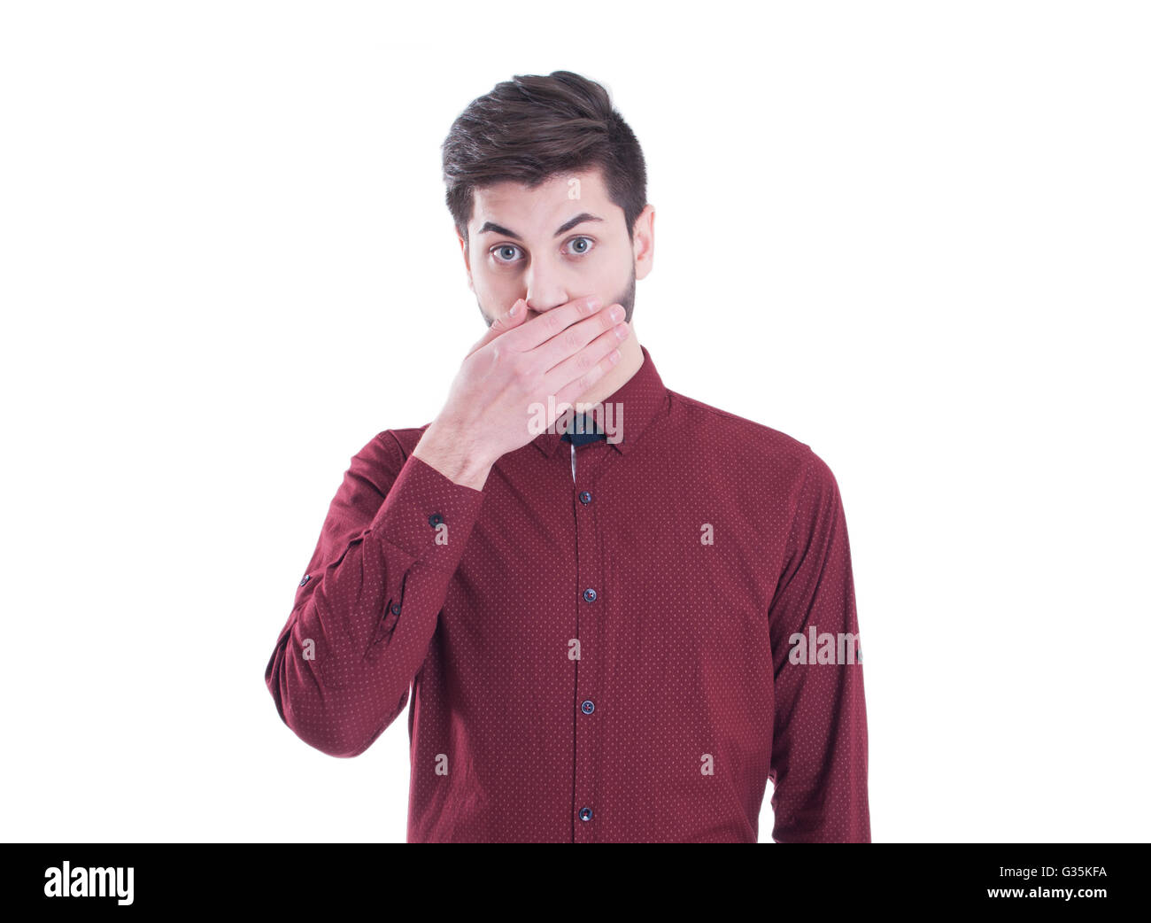 Young man covering his mouth with his hand, isolated on white ...