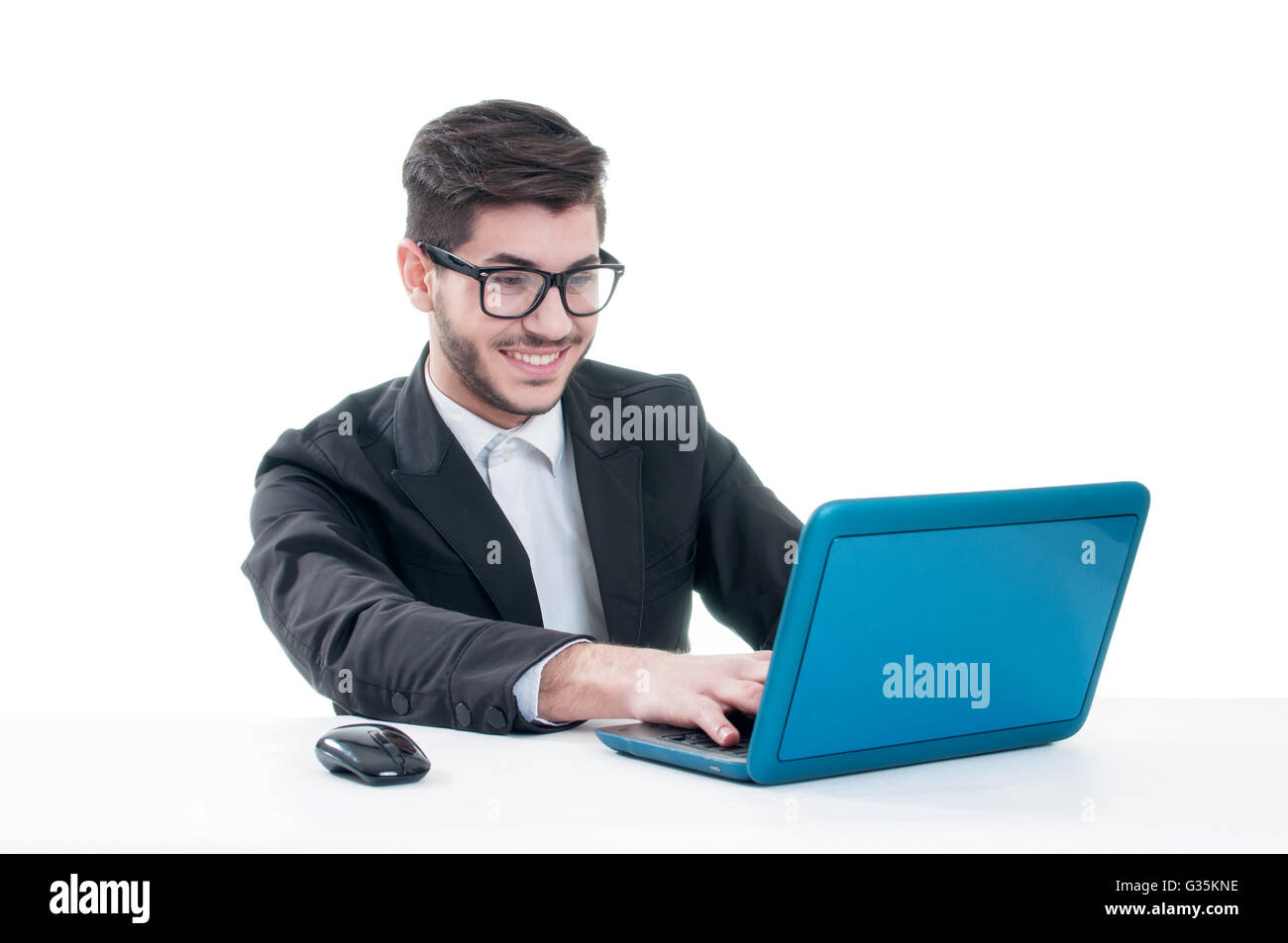 Smiling young man chatting on his laptop. Isolated on white background ...