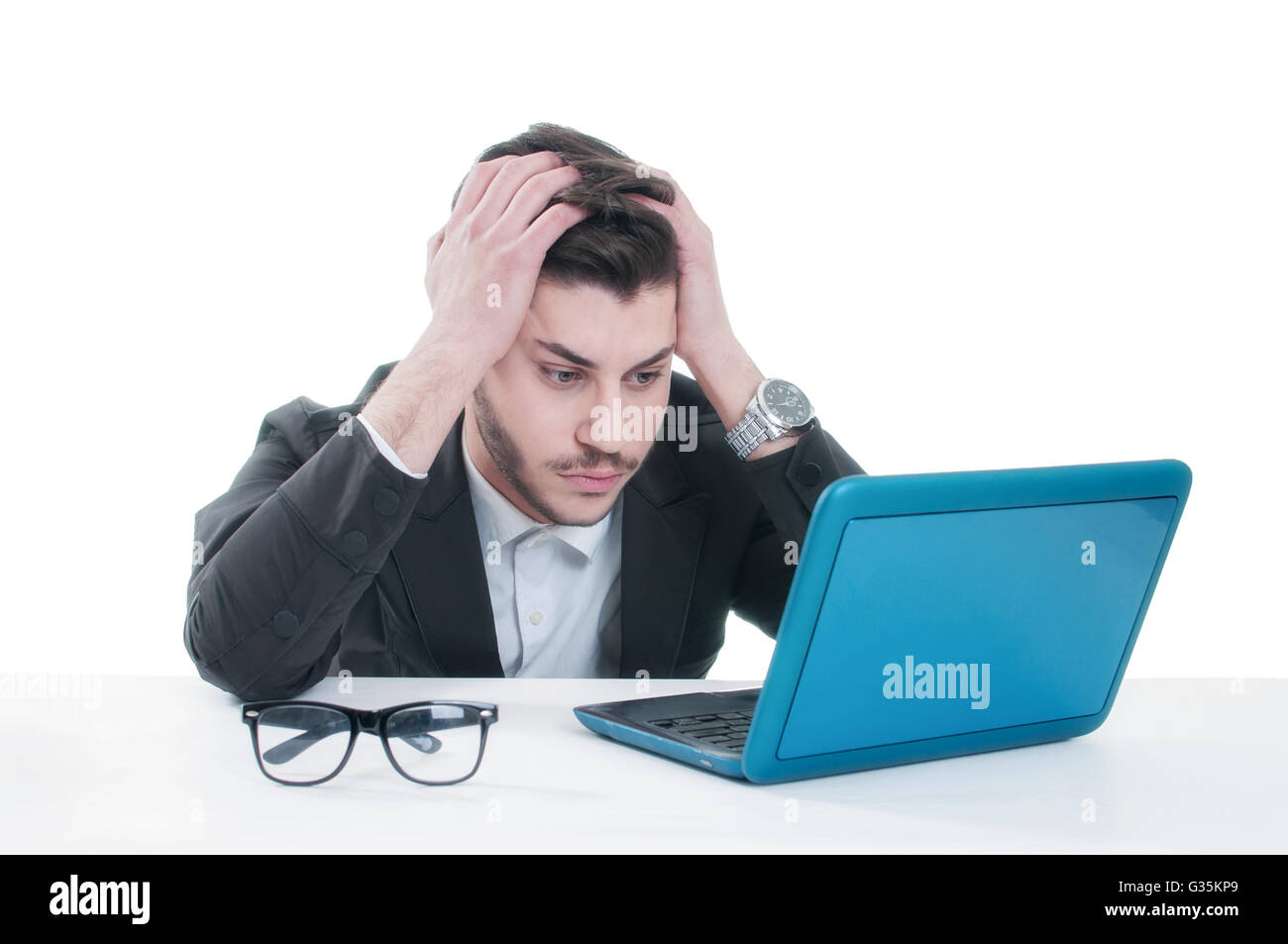 Young business man looking at his laptop with disappointment. Isolated ...
