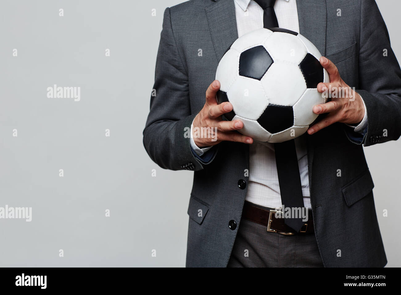 Soccer ball in hands Stock Photo - Alamy