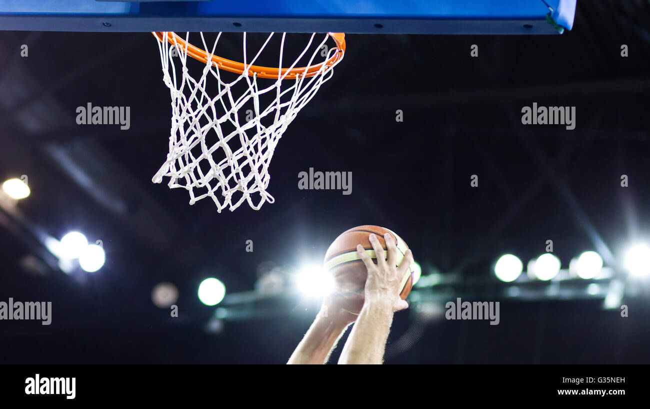 Basketball going through the hoop at a sports arena (intentional ...