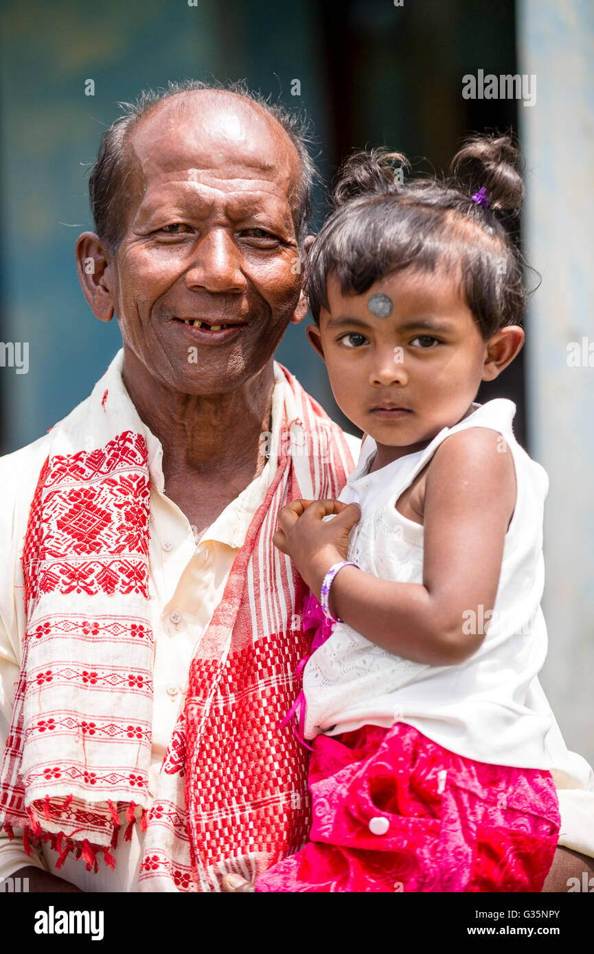 A young girl is held by a relative in Pan Bari Village in the Kaziranga ...