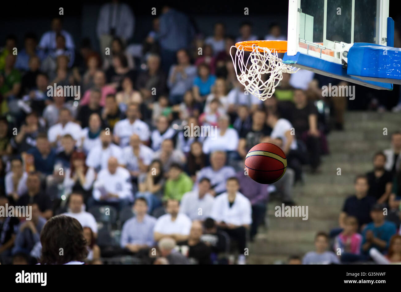 Basketball going through the hoop at a sports arena (intentional ...