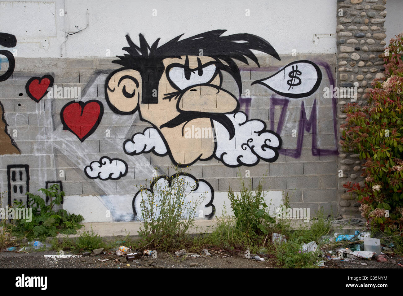 Graffiti art crime on wall of derelict garage building France Stock ...