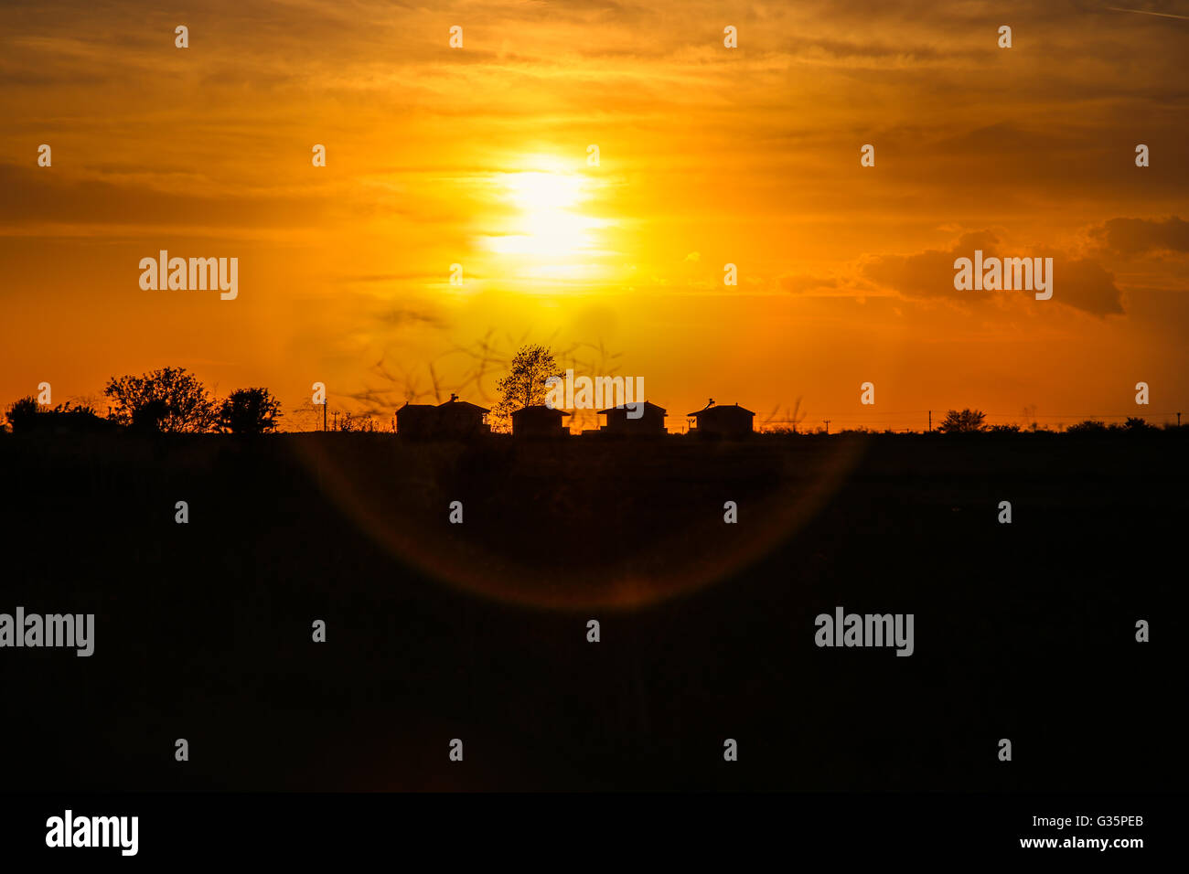 Sunset over the village Stock Photo - Alamy