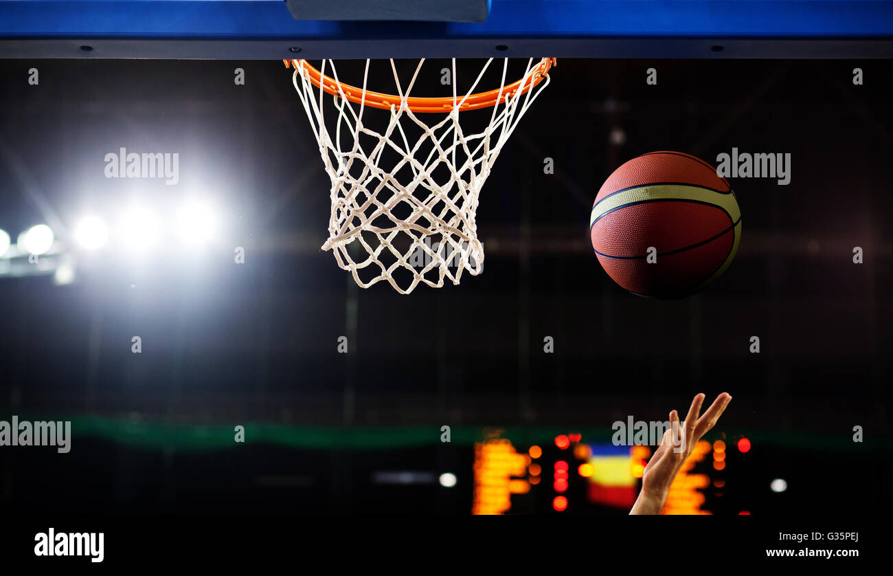 Basketball going through the hoop at a sports arena (intentional ...