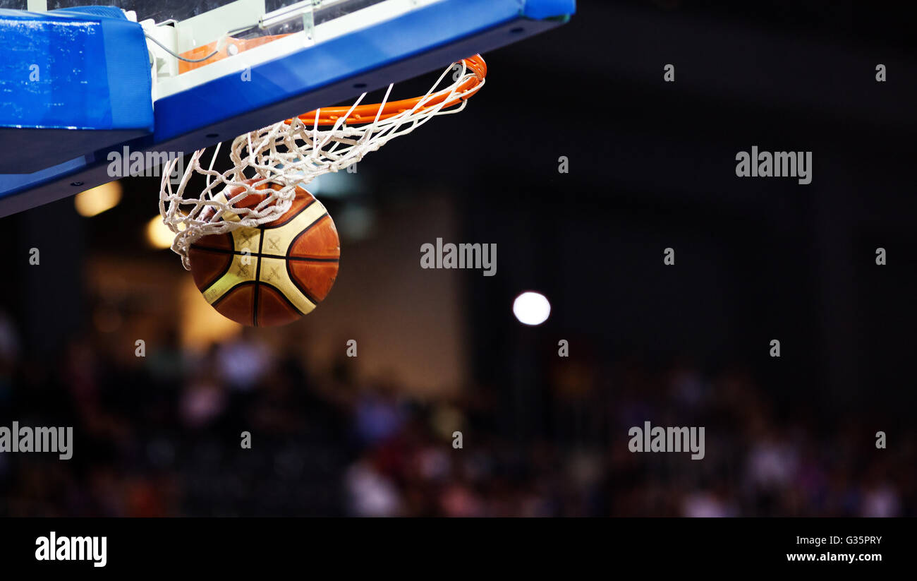 Basketball going through the hoop at a sports arena (intentional ...
