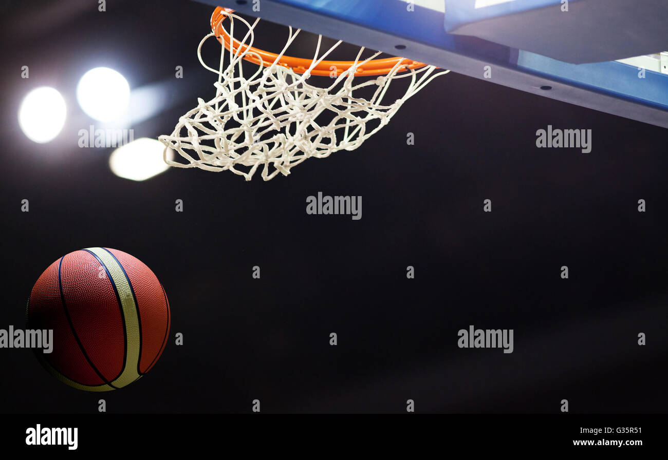 Basketball going through the hoop at a sports arena (intentional ...