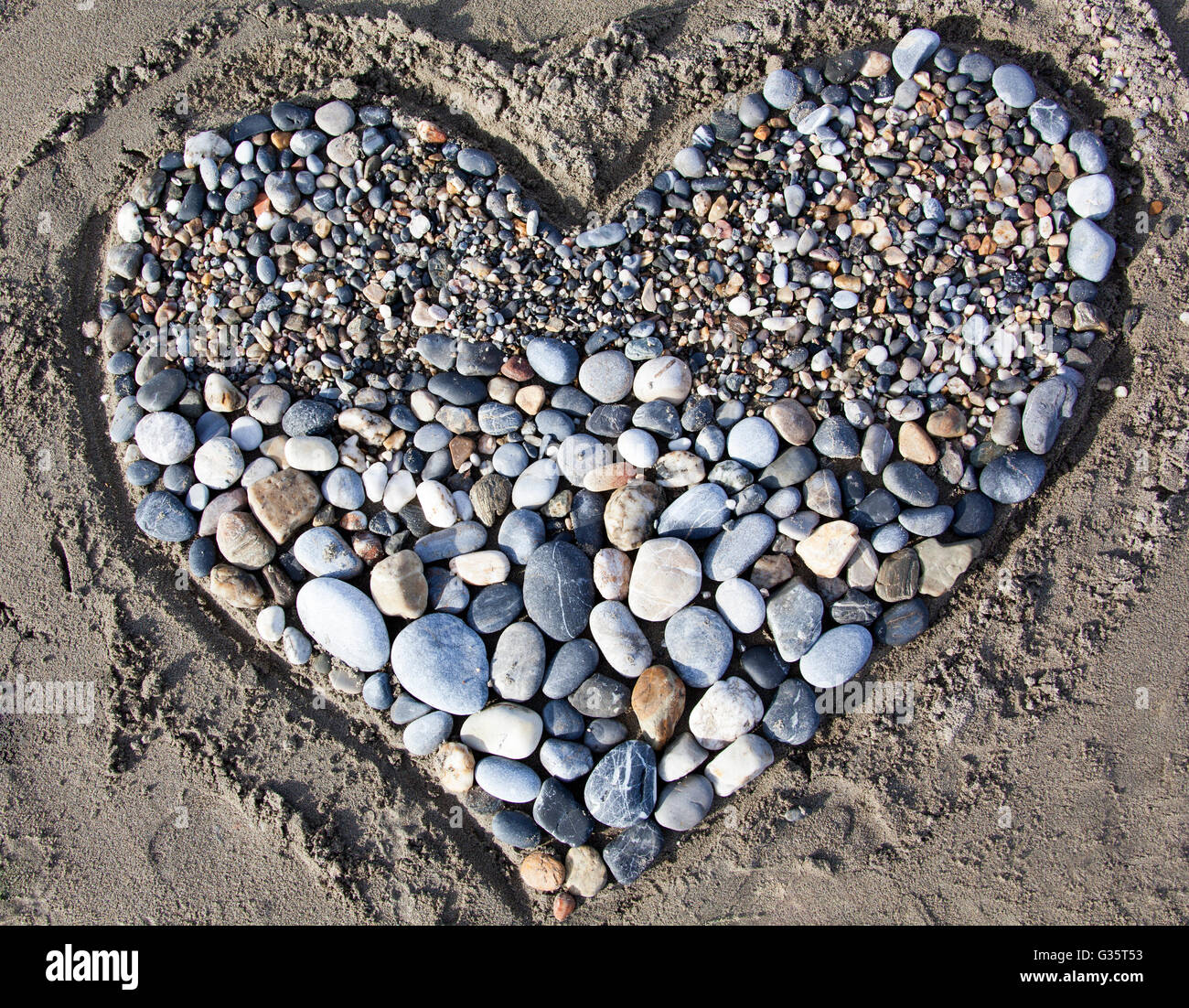 Heart shape on the beach with stones hi-res stock photography and ...