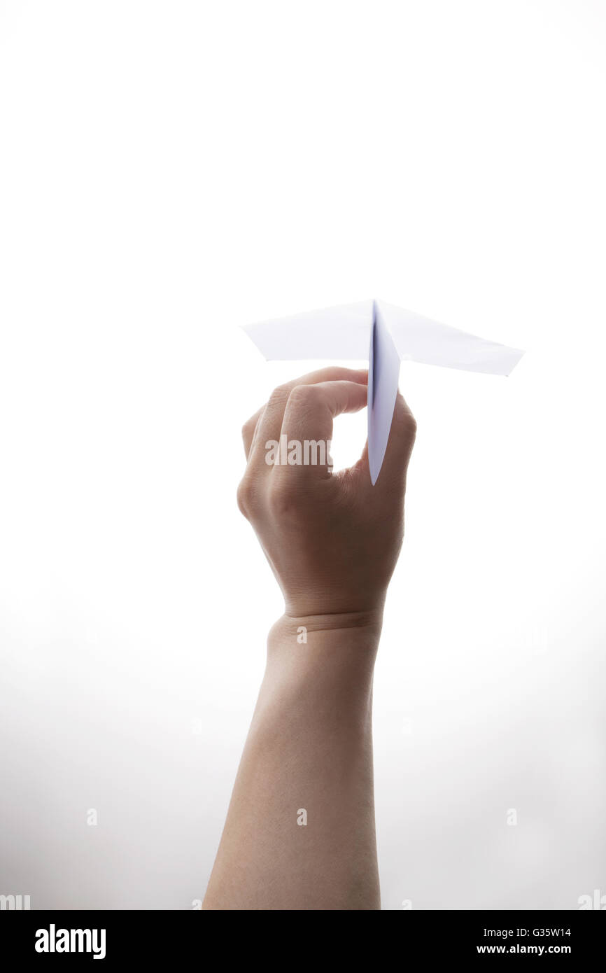 Hand throwing paper plane isolated on white background Stock Photo - Alamy