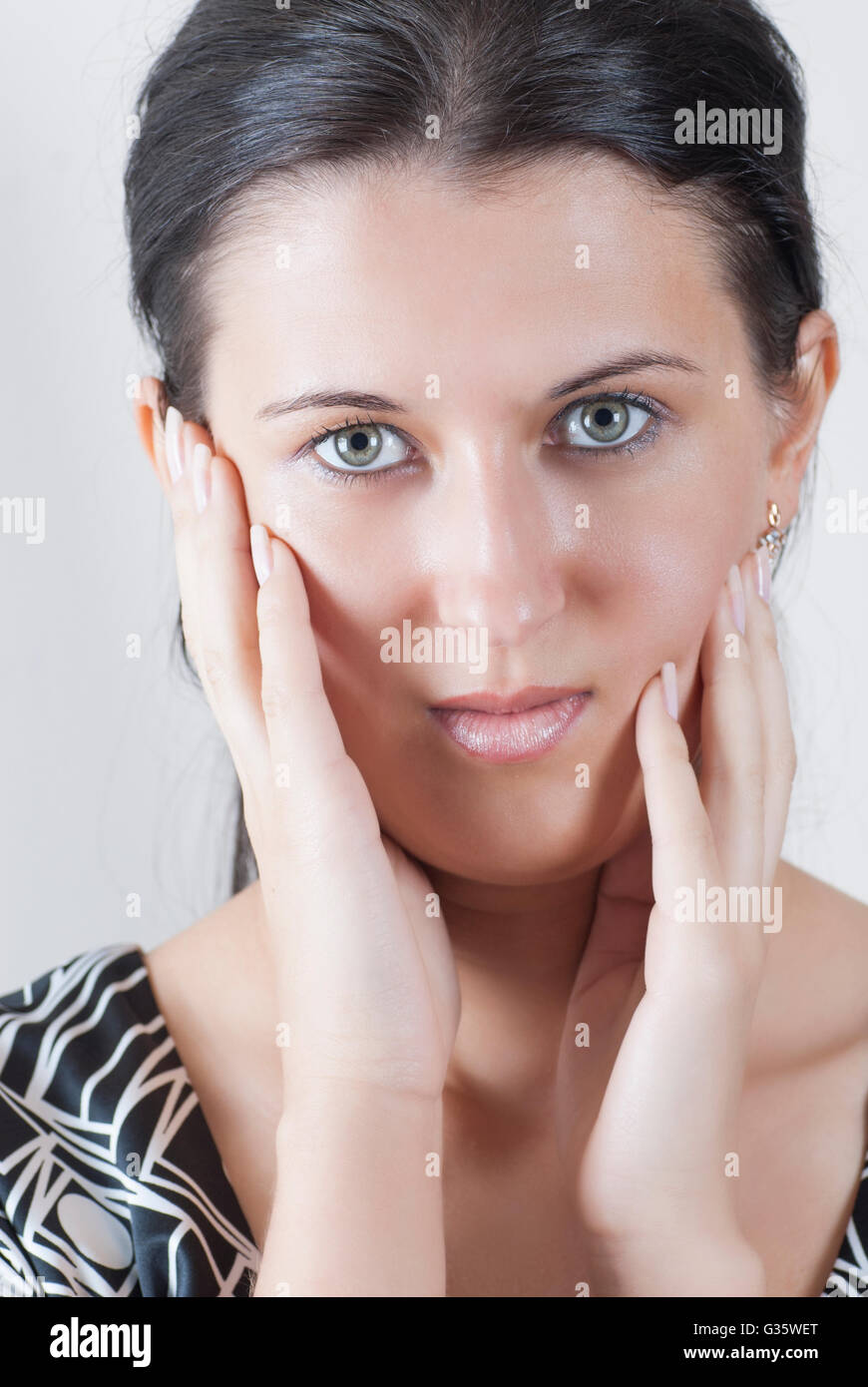 Beautiful young woman hands touching face Stock Photo - Alamy