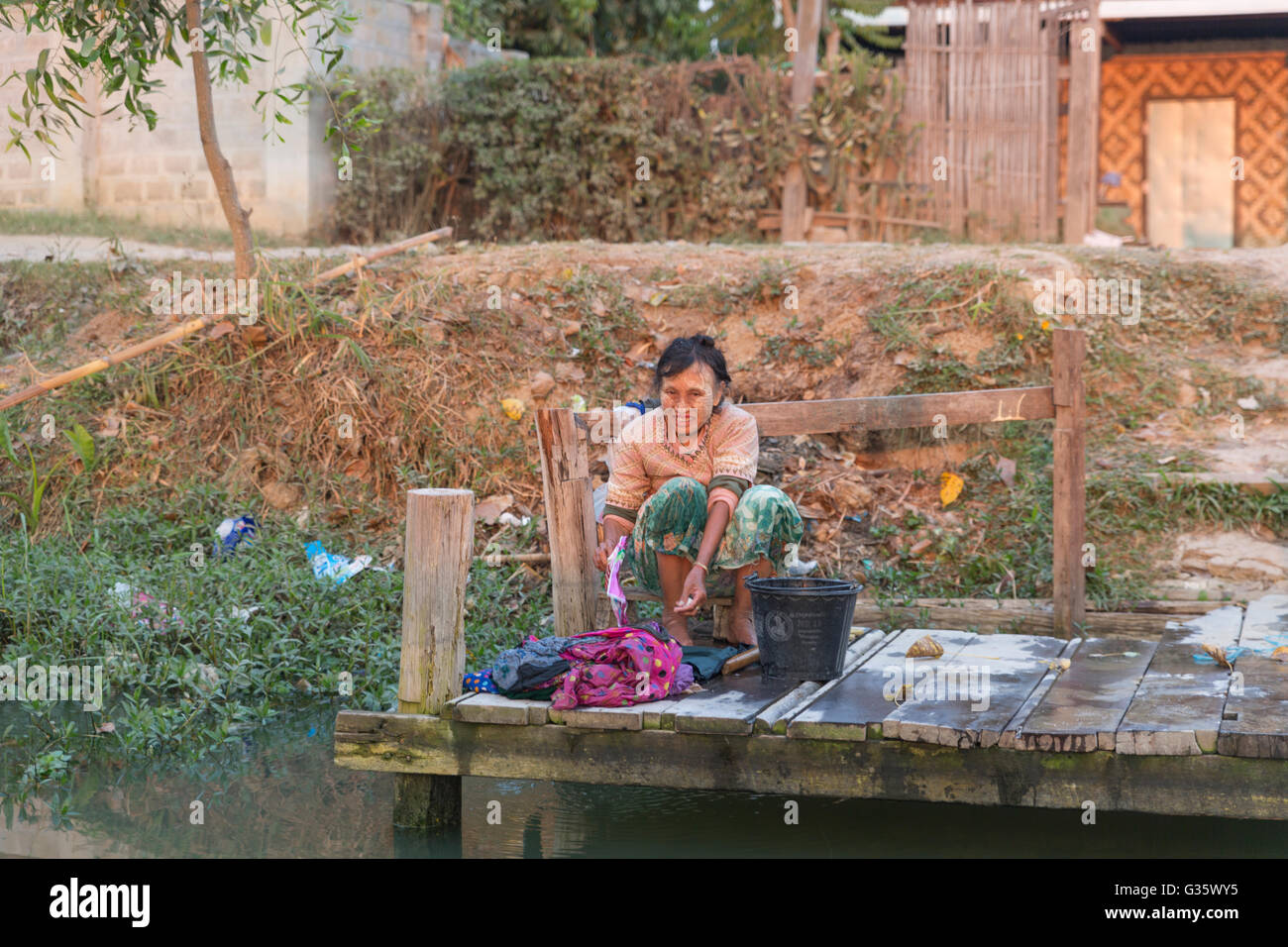 Woman washing clothes in the river on Inle Lake, Nyaung Shew, Burma ...