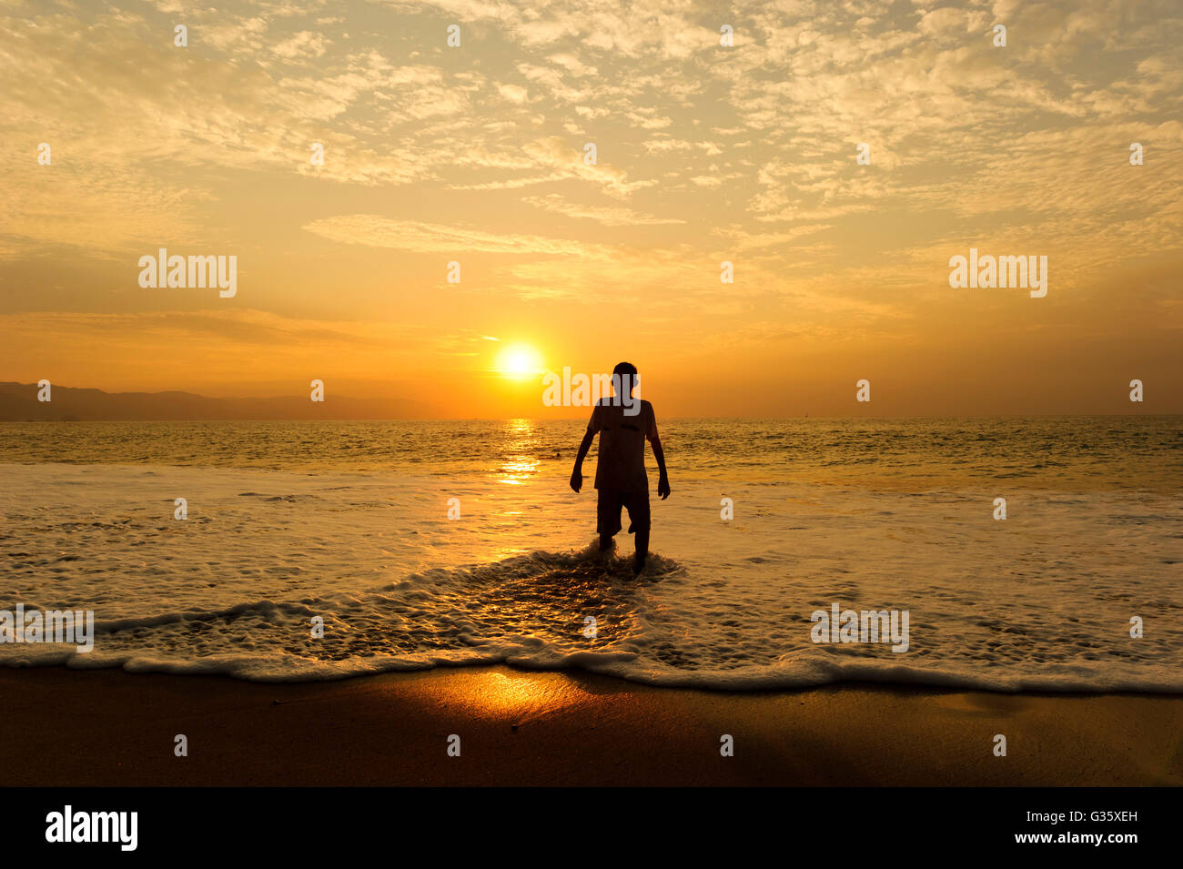 Man standing on a beach sunset High Resolution Stock Photography and ...