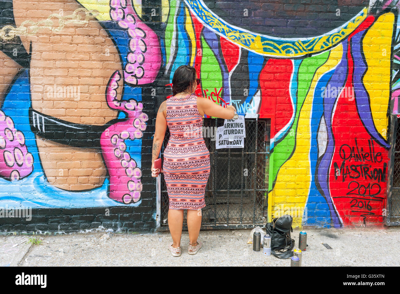 Danielle Mastrion works on her mural in Bushwick, Brooklyn in New York ...