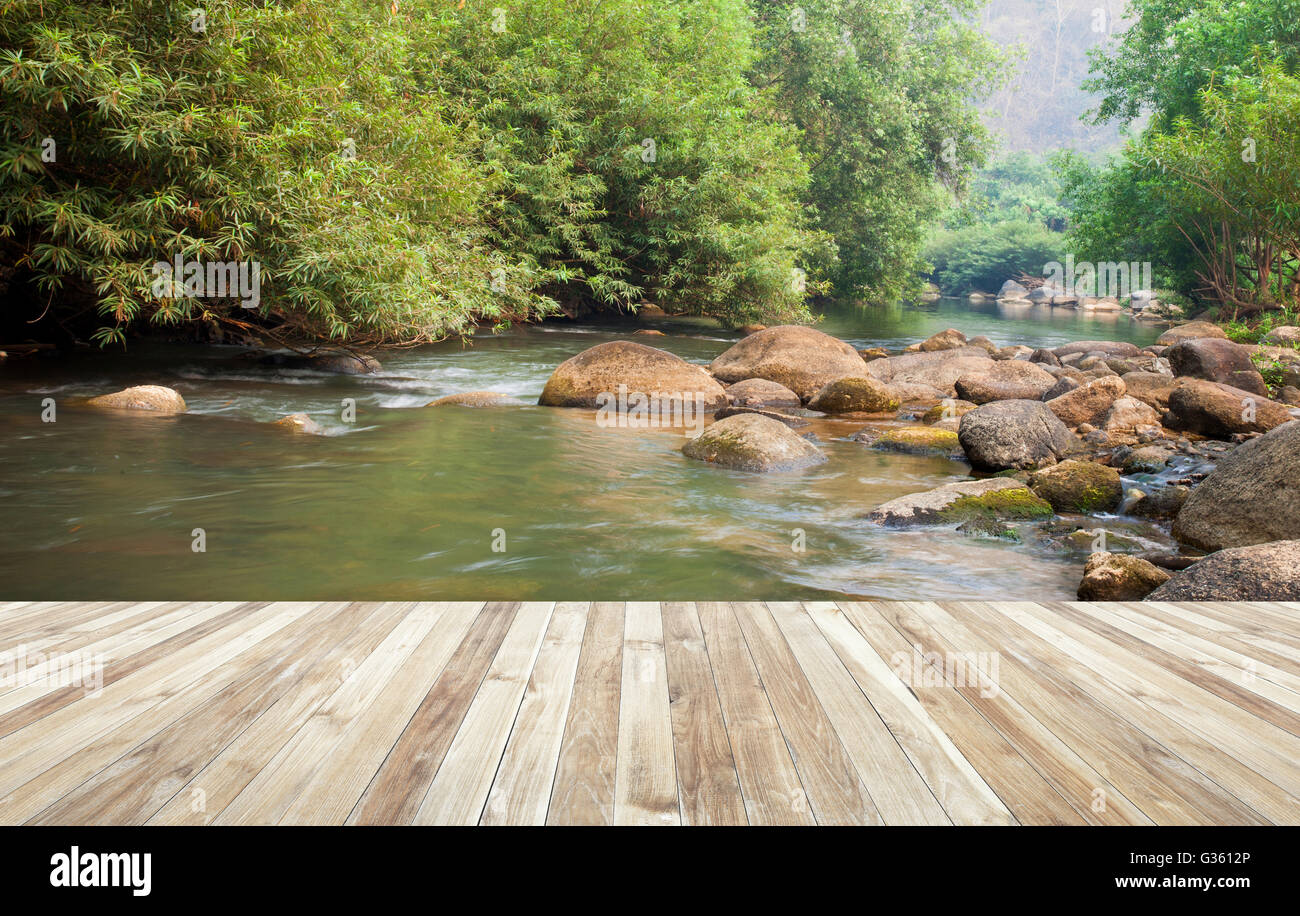 Wood table and river and stone with tree in forest beautiful nature of ...