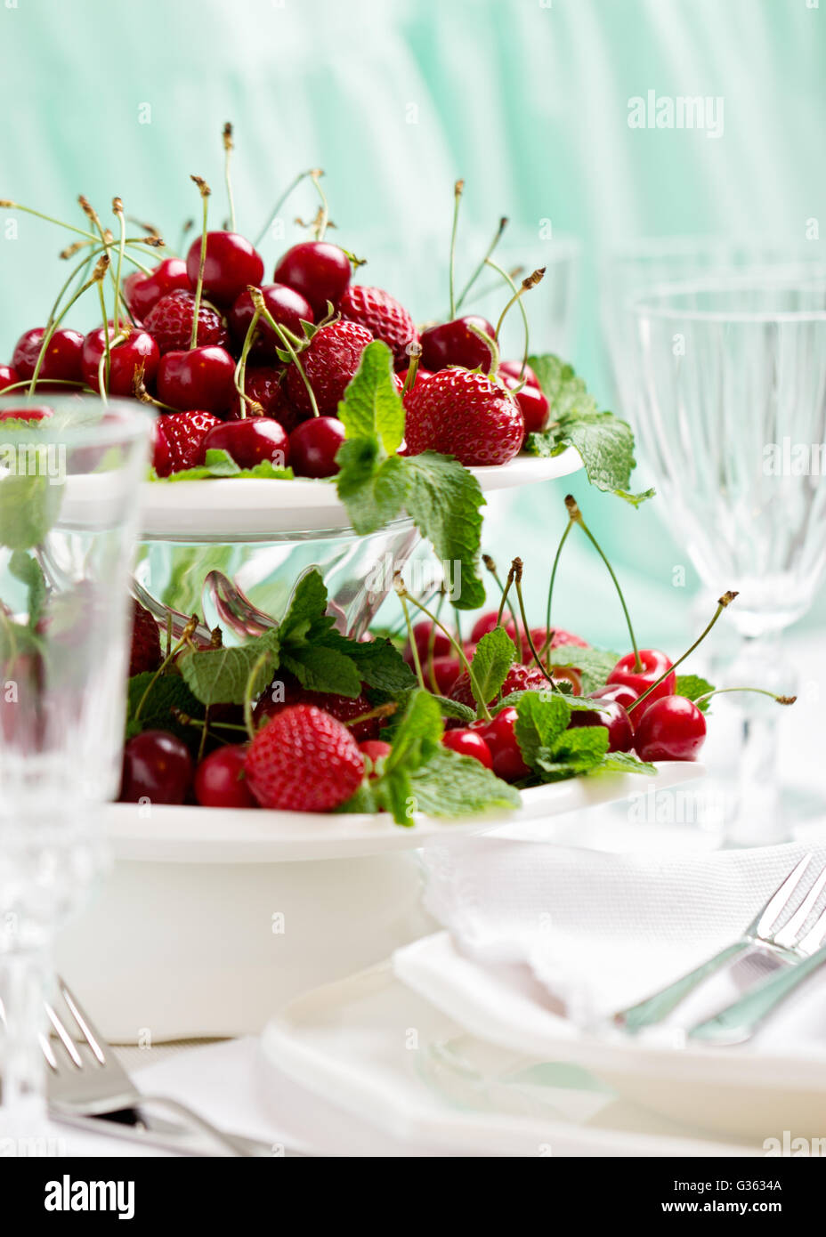 Summer. Table setting. Berries - strawberries and cherries at a stand ...