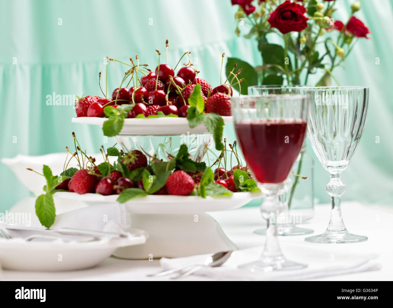 Summer. Table setting. Berries - strawberries and cherries at a stand ...
