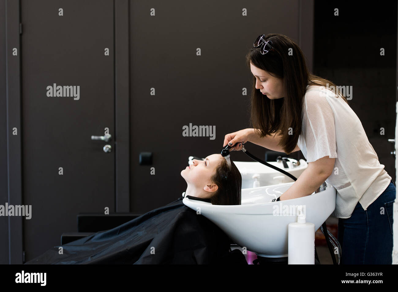 Stylist drying woman hair hi-res stock photography and images - Alamy