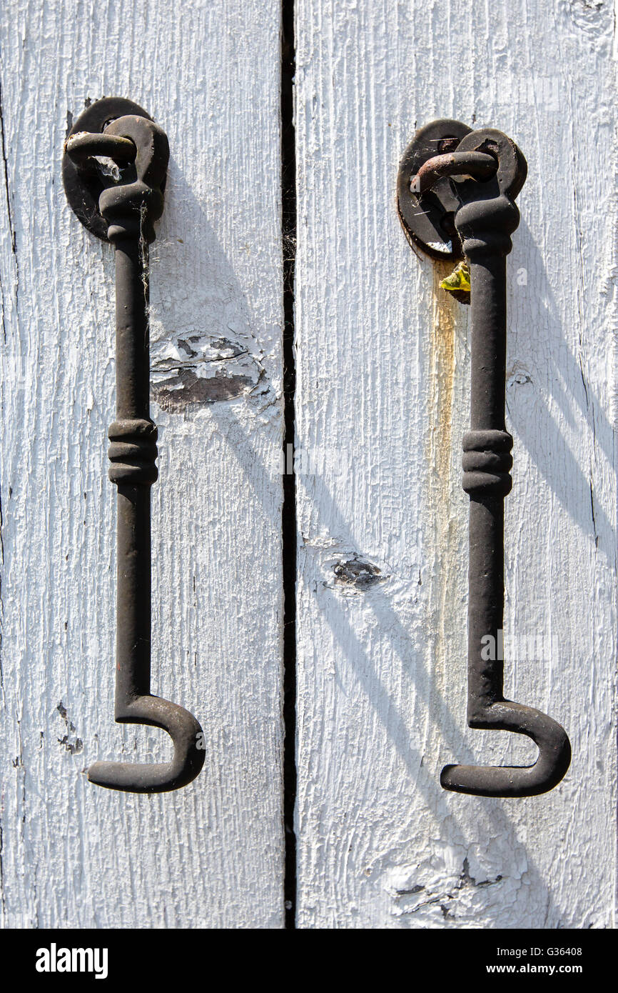 Two Steel Hooks Hanging Off a White Painted Wooden Door Frame in Close ...