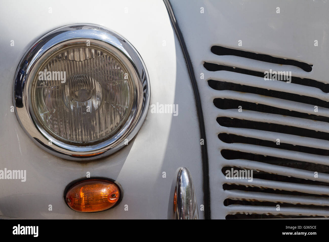 front view close up of a vintage white round car chrome headlight and ...