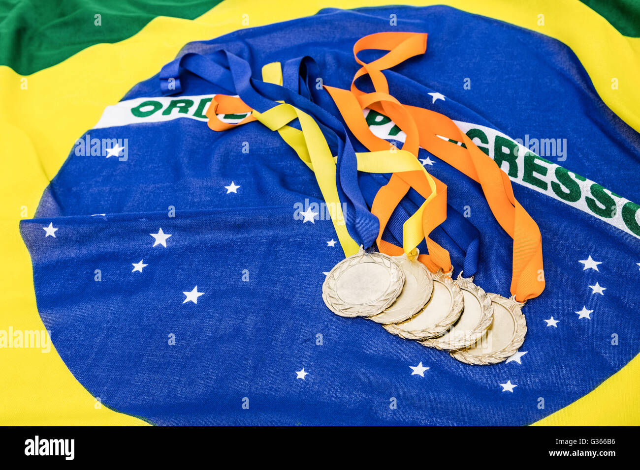 Close-up of gold medals on brazilian flag Stock Photo - Alamy