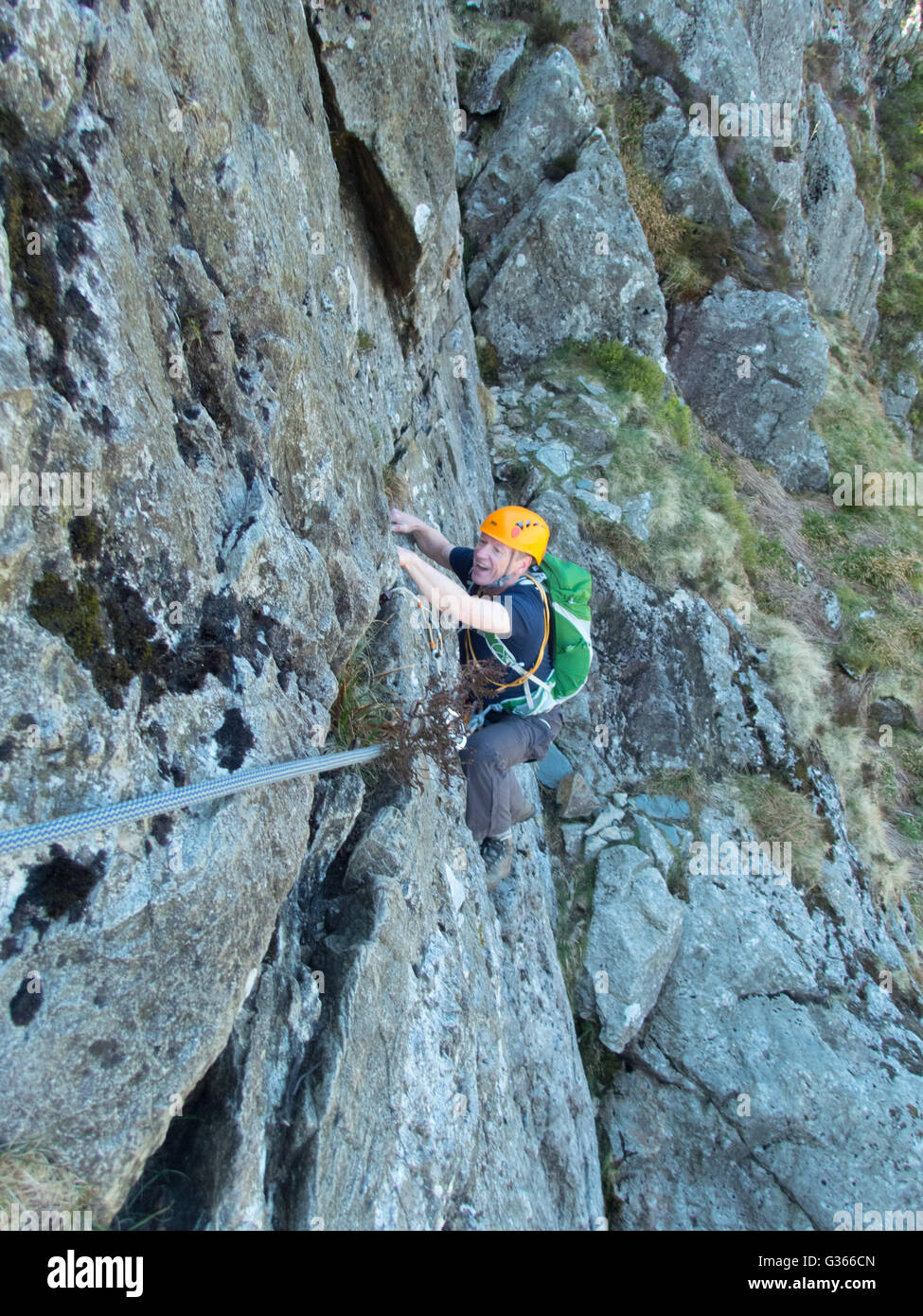A rock climbing enjoying sunshine on the classic rock climb 'Corvus ...