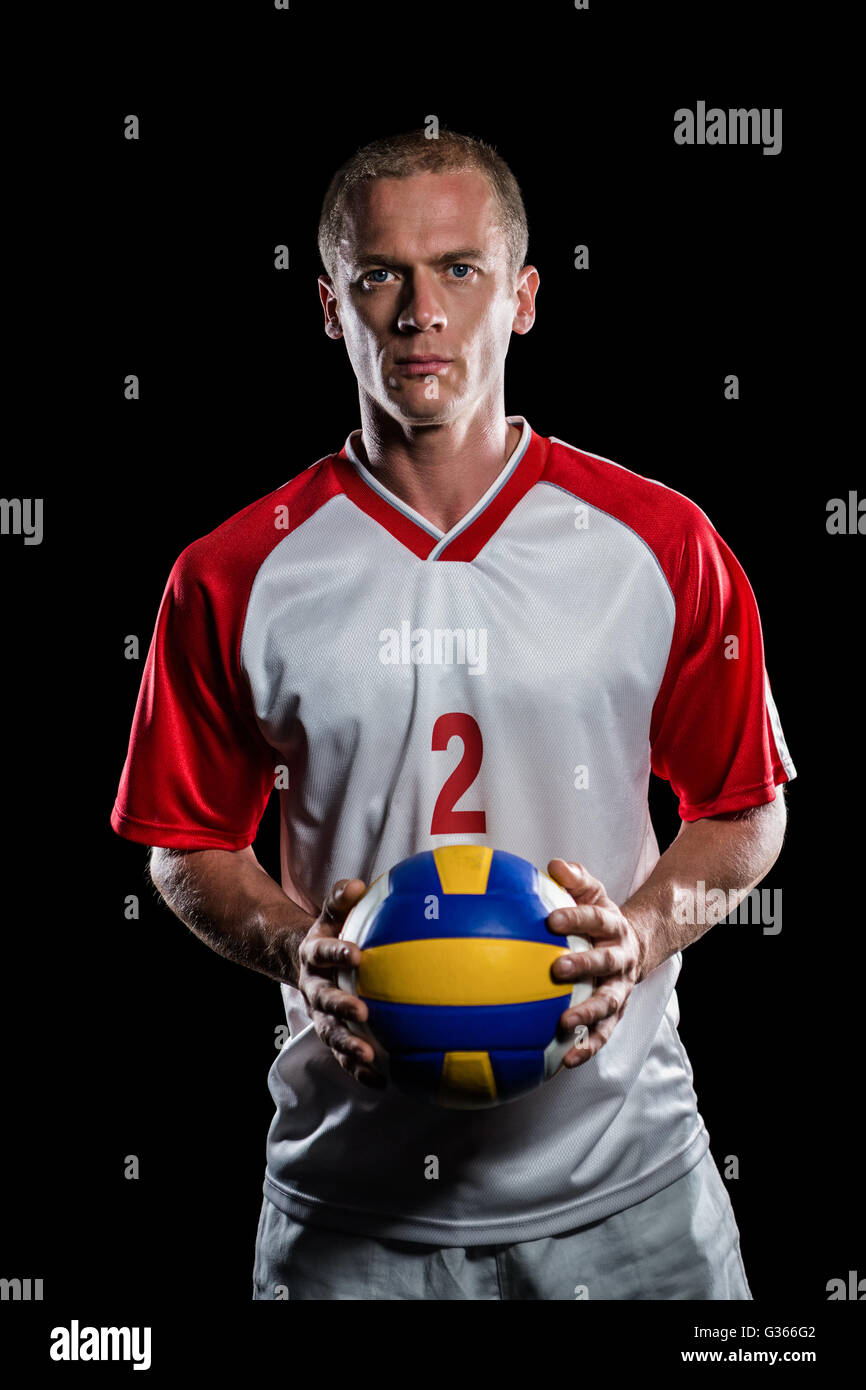 Sportsman holding a volleyball Stock Photo - Alamy