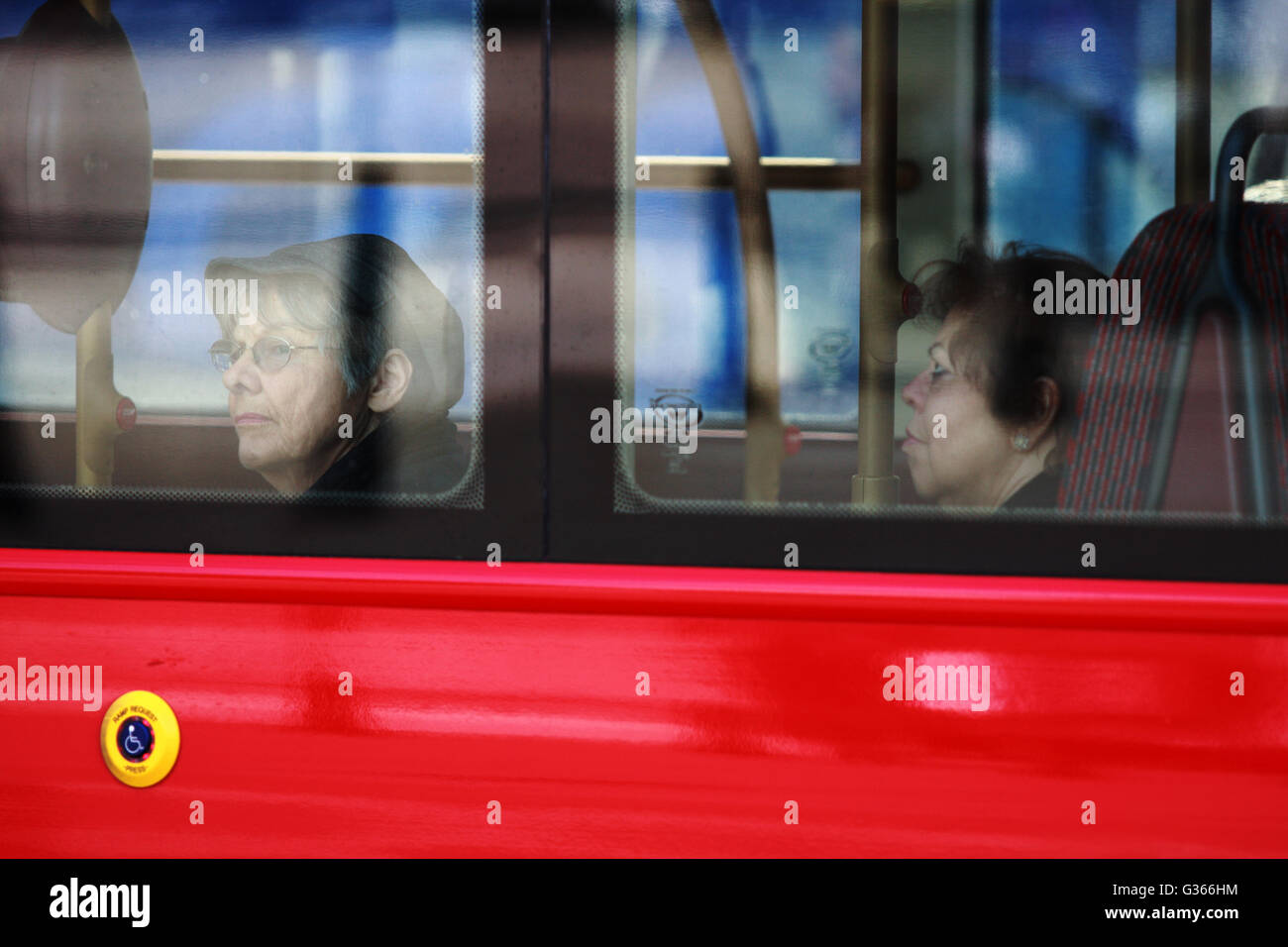 A view of two women sitting on a red London bus Stock Photo - Alamy