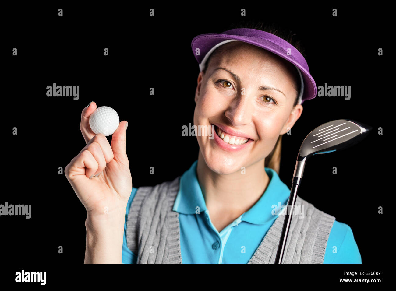 Golf player posing with a golf club and golf ball Stock Photo - Alamy