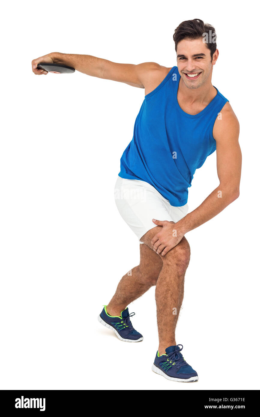 Male athlete playing discus throw on white background Stock Photo - Alamy