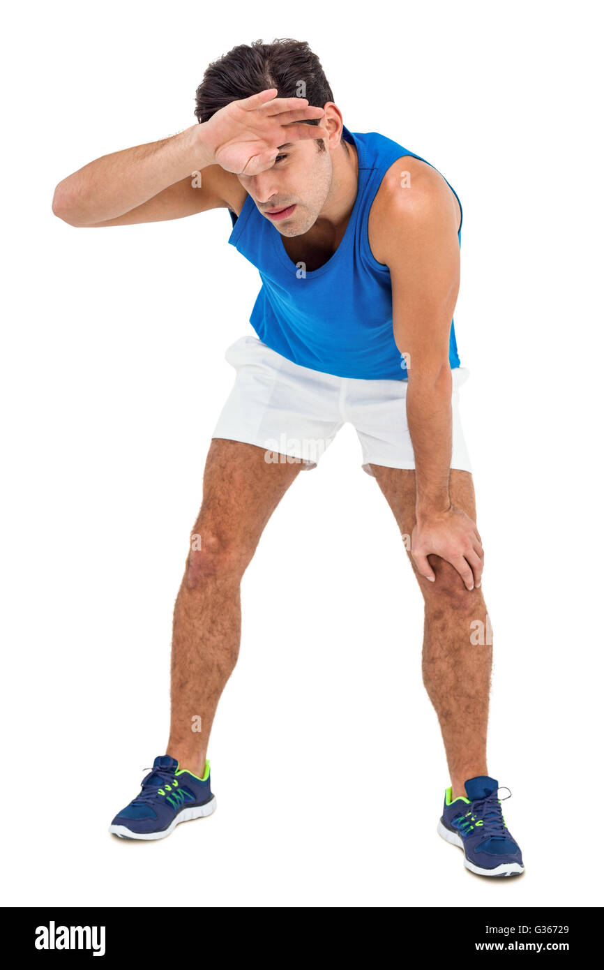 Tired athlete wiping his sweat with hand Stock Photo - Alamy