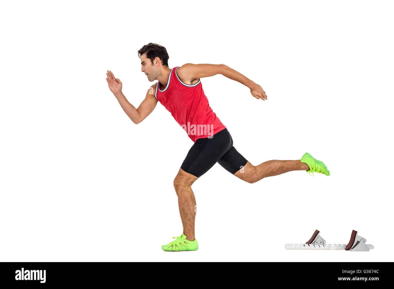 Confident male athlete running from starting blocks Stock Photo - Alamy