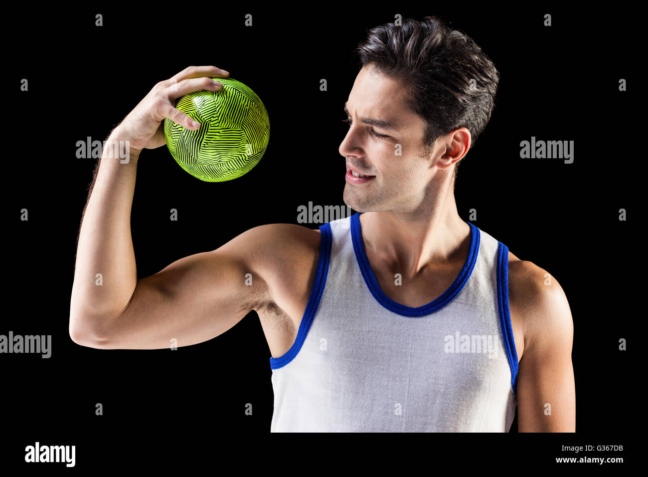 Happy male athlete holding a ball Stock Photo - Alamy