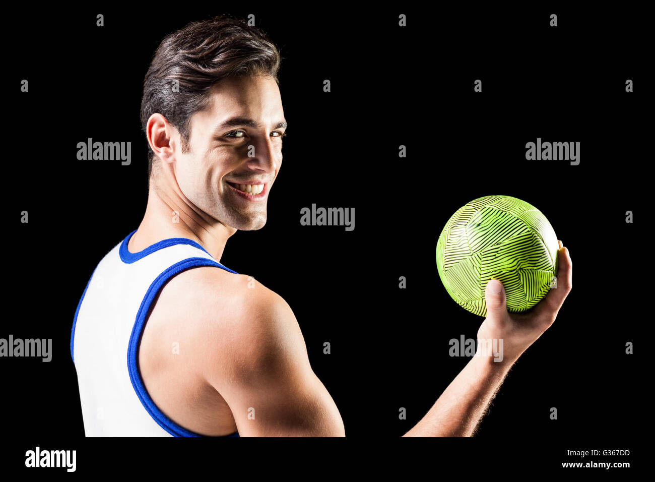 Portrait of happy athlete man holding ball Stock Photo - Alamy