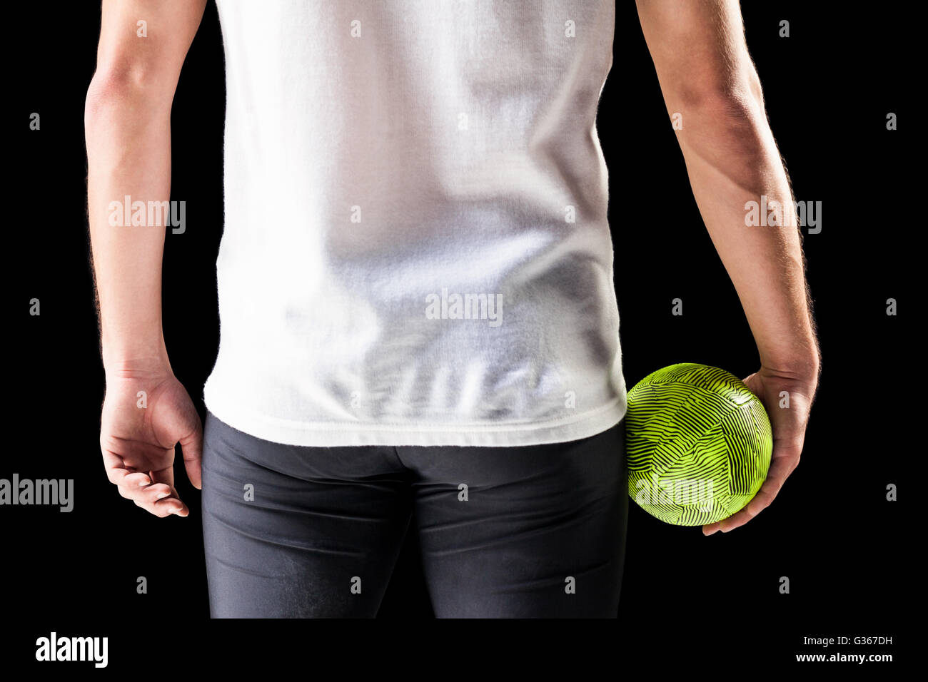 Mid section of athlete man holding ball Stock Photo - Alamy
