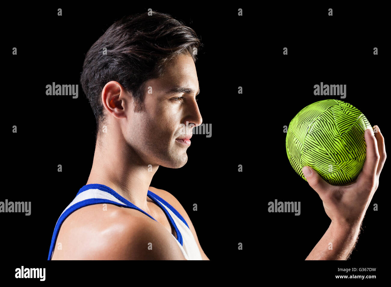Confident athlete man holding a ball Stock Photo - Alamy
