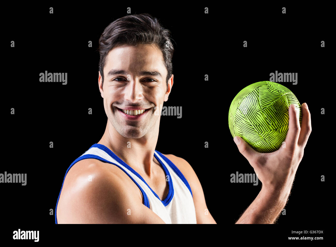 Portrait of athlete man holding a ball Stock Photo - Alamy
