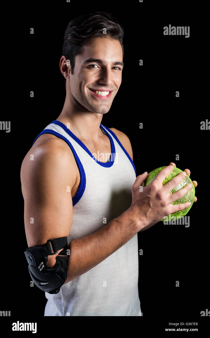 Portrait of happy athlete man holding a ball Stock Photo - Alamy
