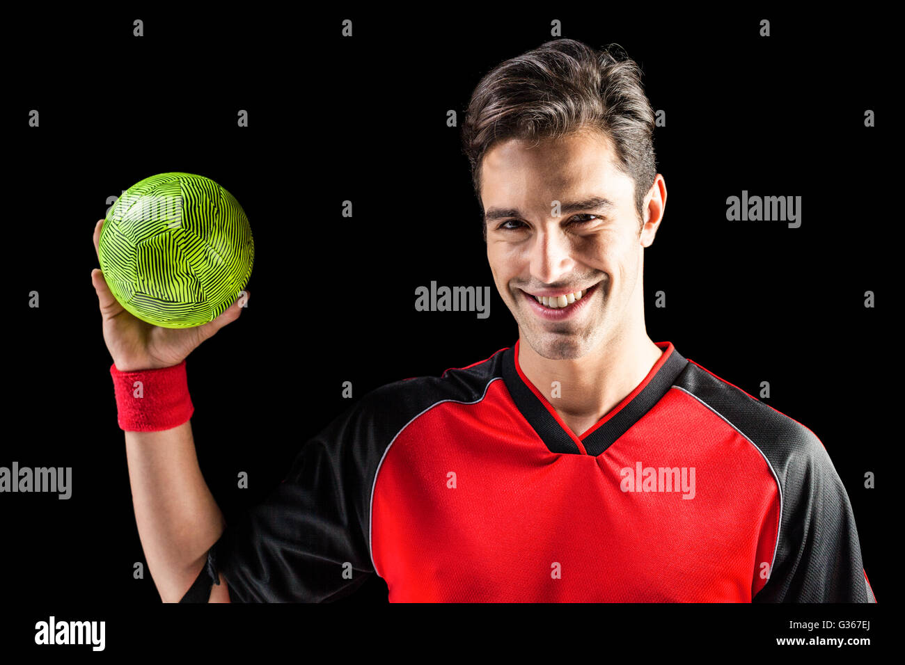 Portrait of happy athlete man holding a ball Stock Photo - Alamy