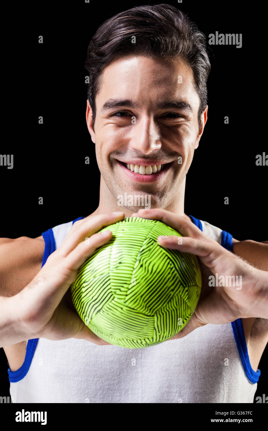 Portrait of happy athlete man holding ball Stock Photo - Alamy