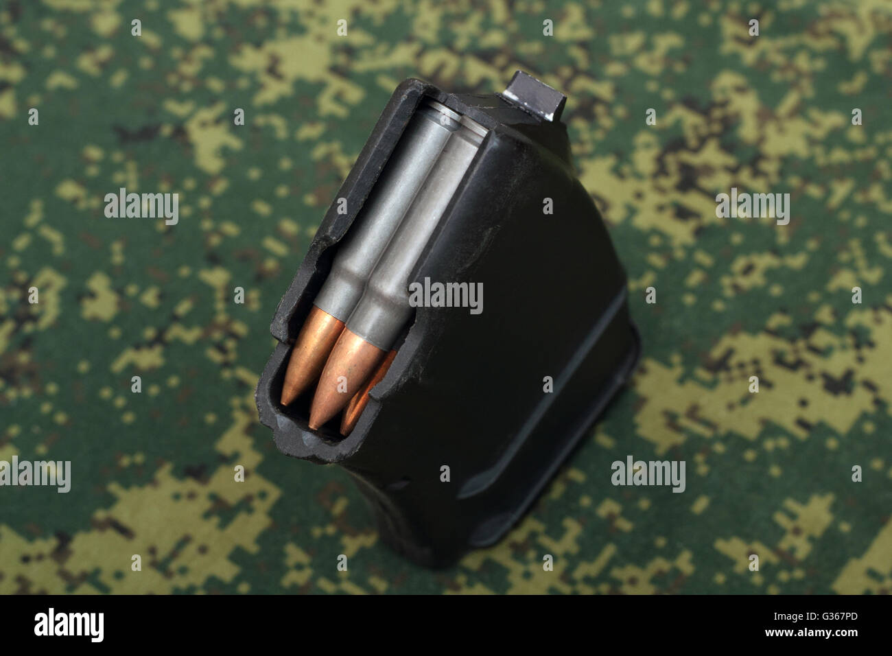 Filled magazine viewed from mouth on digital camouflage background ...